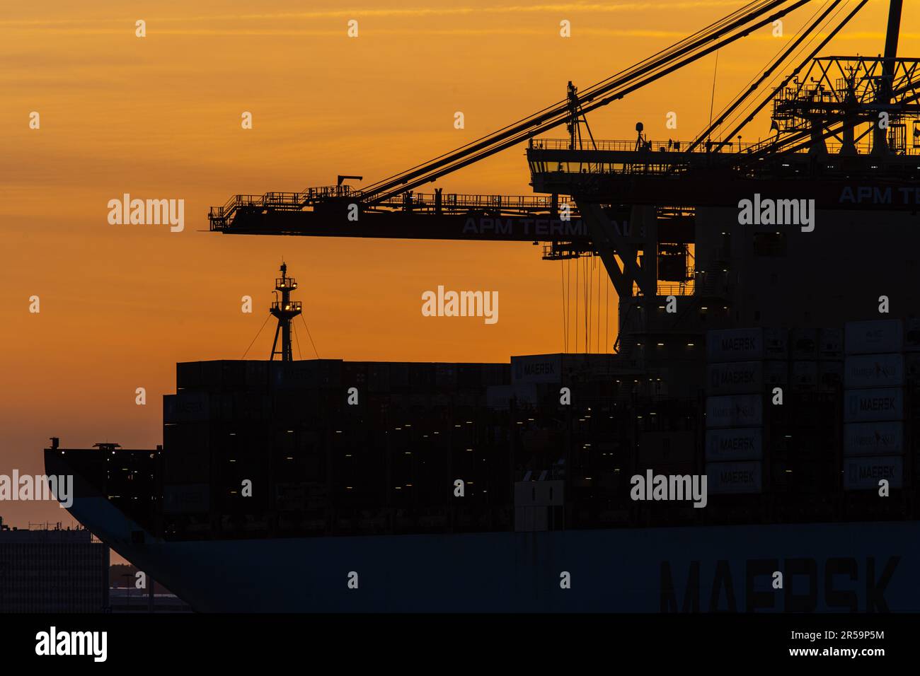 Large container vessel loading goods at port Stock Photo - Alamy