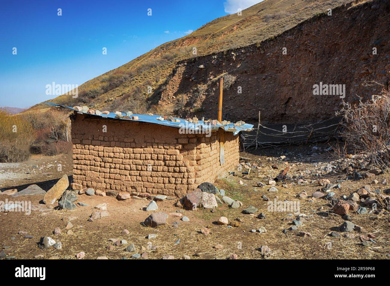 Clay hut. Beautiful view of cliffs from yellow red limestone. Kyzyl suu ...