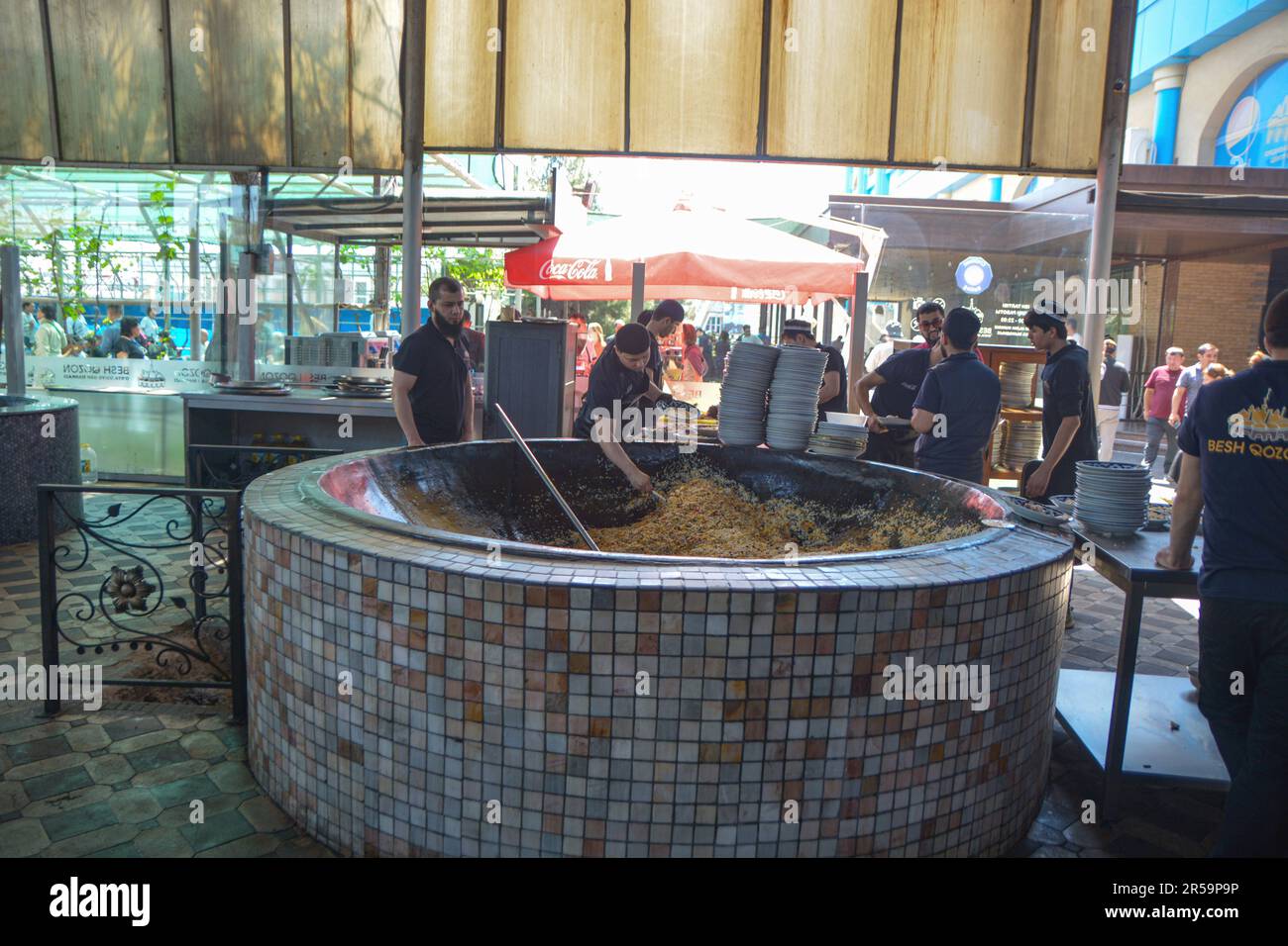 Tashkent, Uzbekistan - 5 May, 2023: Bwsh kazan. Cook stirs rice in a ...