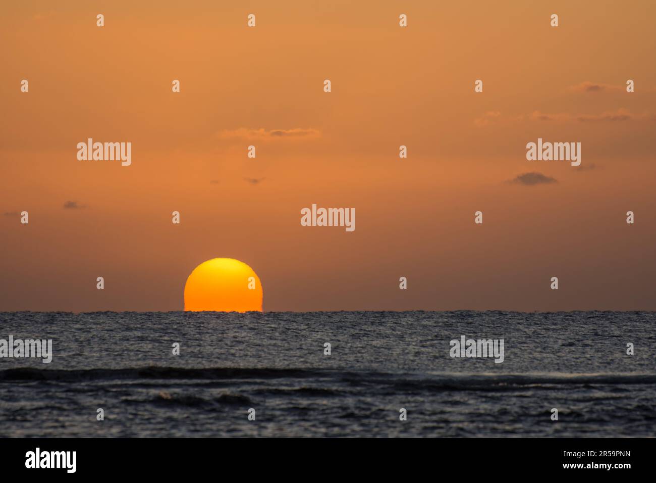amazing sunrise with a distorted orange sun at the horizon from the red ...