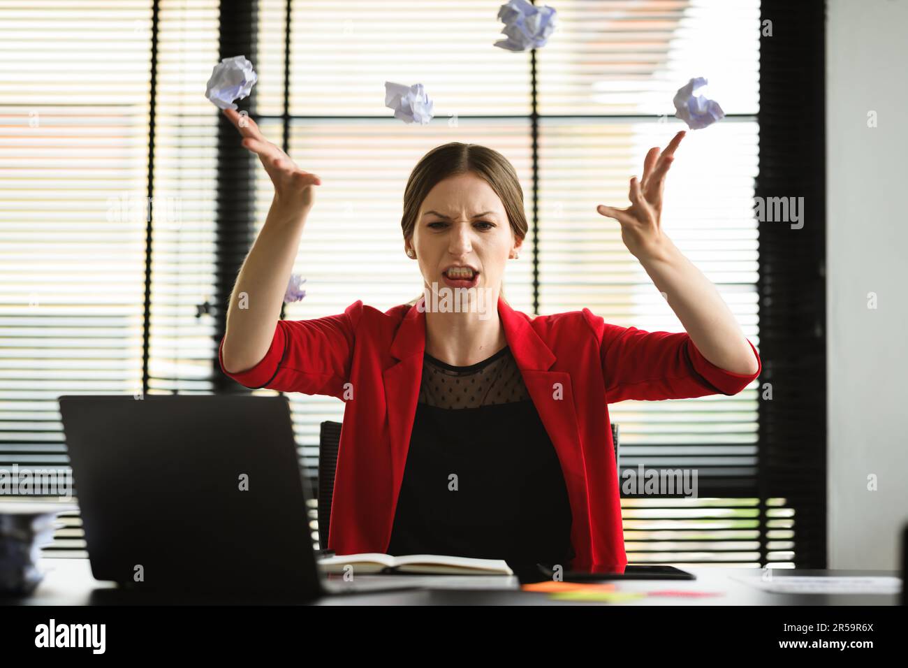 Stressed businesswoman throwing crumpled paper, having problem with ...