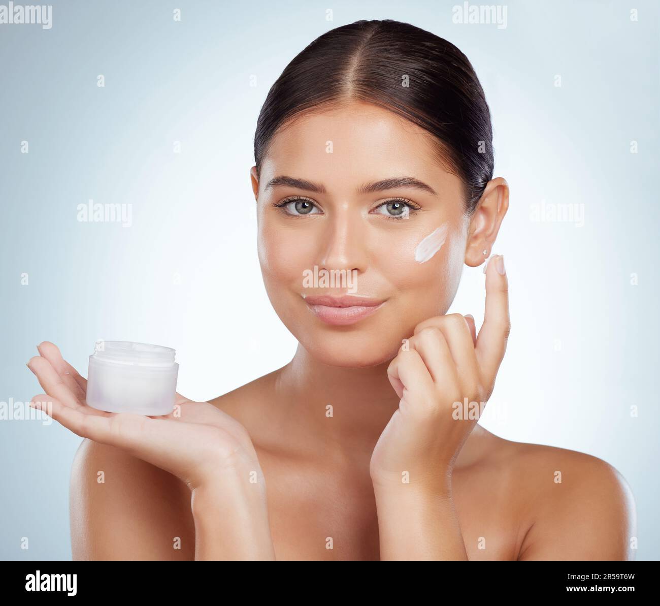 Face, skincare and woman with cream container in studio isolated on a ...