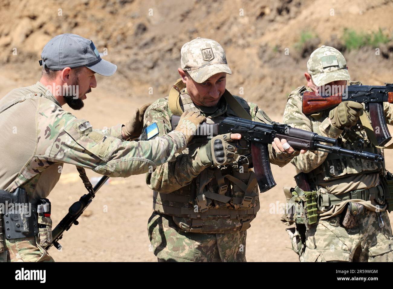 KHARKIV REGION, UKRAINE - JUNE 1, 2023 - An instructor shows how to ...