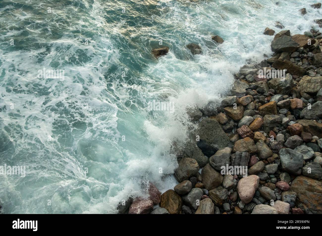 waves crashing against rocks in cinque terre italy Stock Photo - Alamy