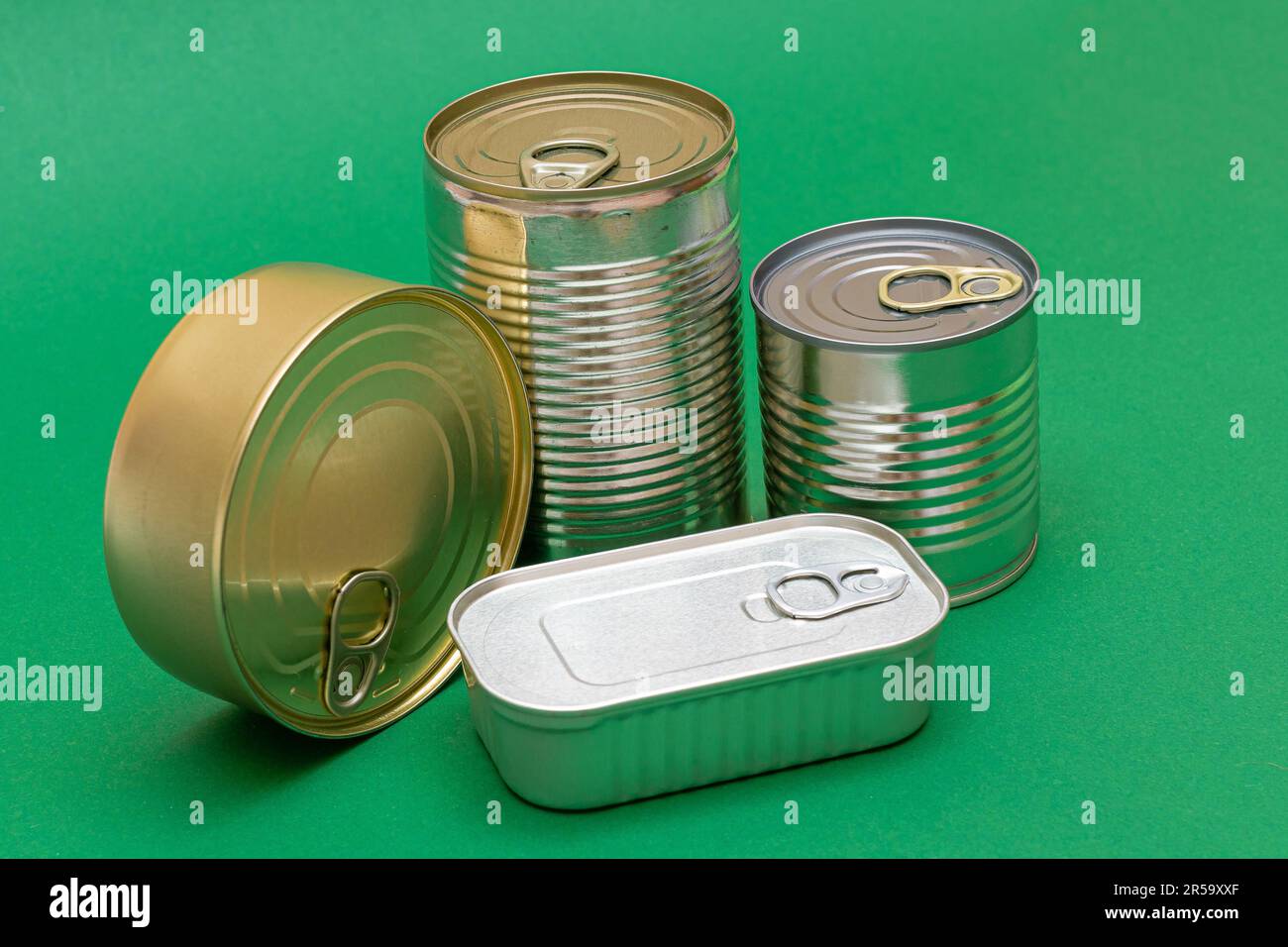 A Group of Stacked Tin Cans with Blank Edges on Green Background ...
