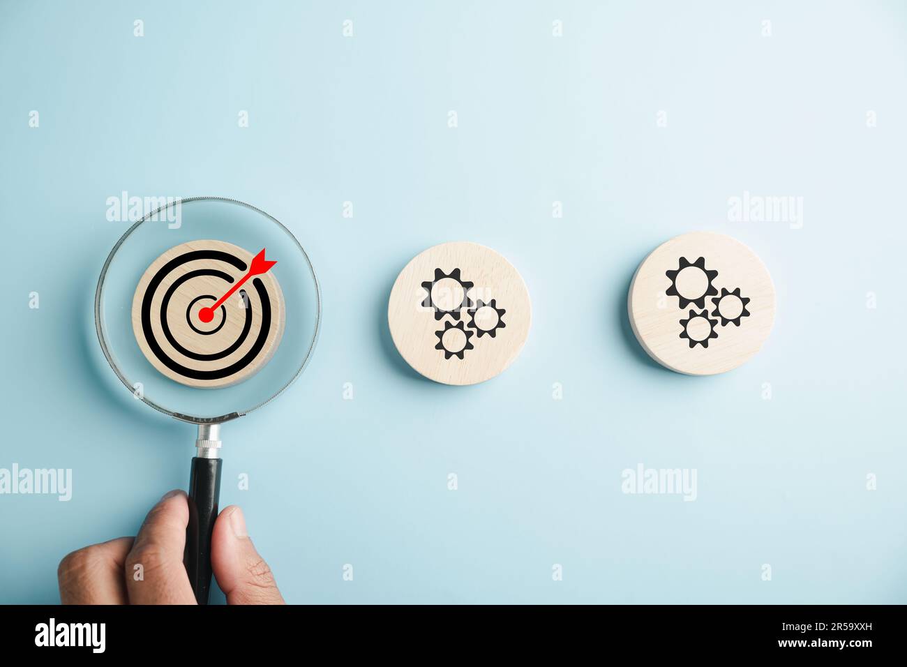 Magnifier in hand, close-up analysis of a target icon Stock Photo - Alamy