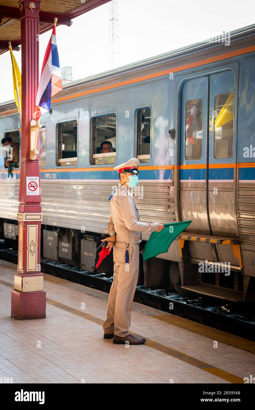 A Thai train guard stands on the platform of Hua Hin Train Station ...
