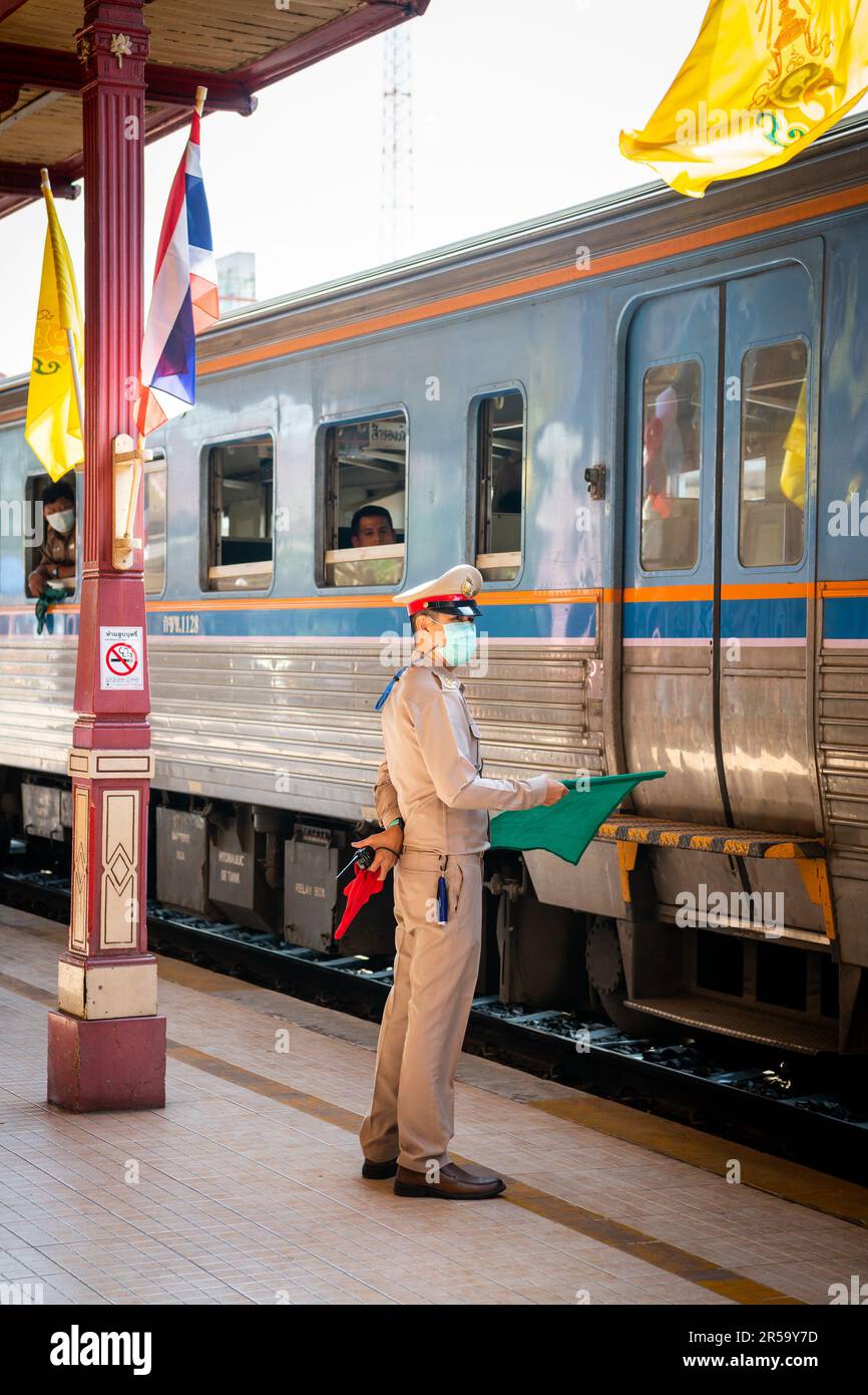 A Thai train guard stands on the platform of Hua Hin Train Station ...