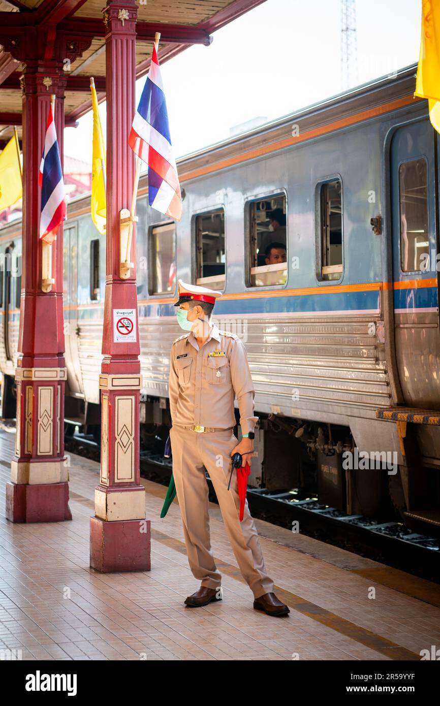 A Thai train guard stands on the platform of Hua Hin Train Station ...
