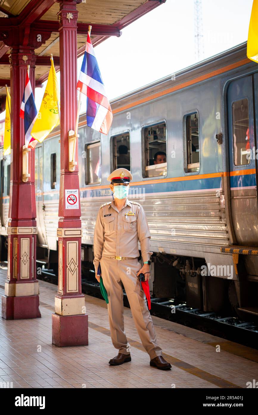 A Thai train guard stands on the platform of Hua Hin Train Station ...