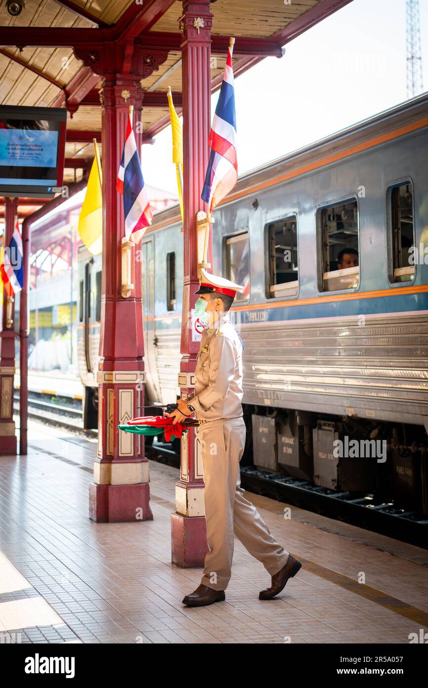 A Thai train guard stands on the platform of Hua Hin Train Station ...