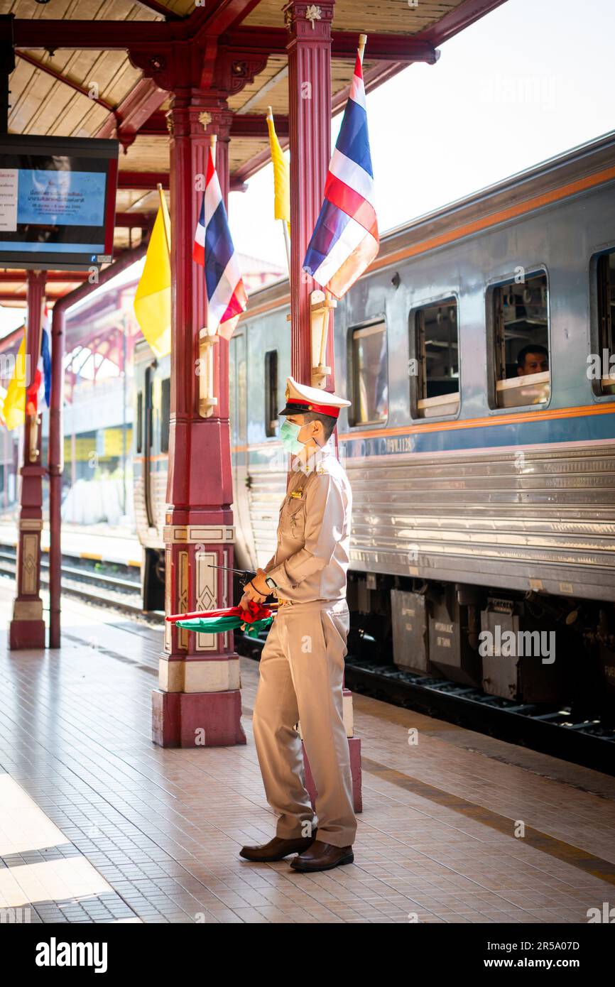 A Thai train guard stands on the platform of Hua Hin Train Station ...