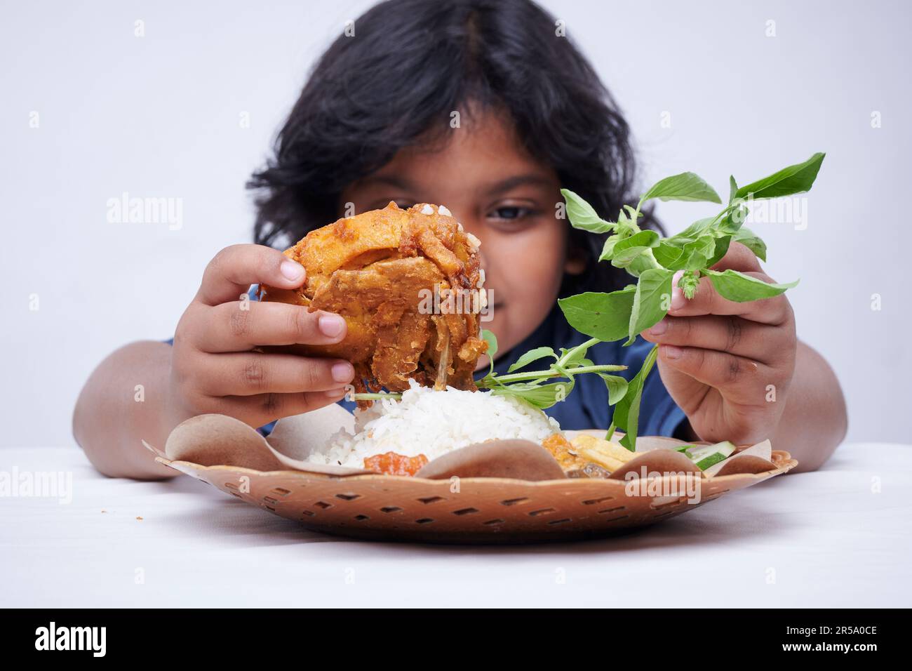 Happy little girl Holding Fried Chicken with Rice and Vegetable Stock ...