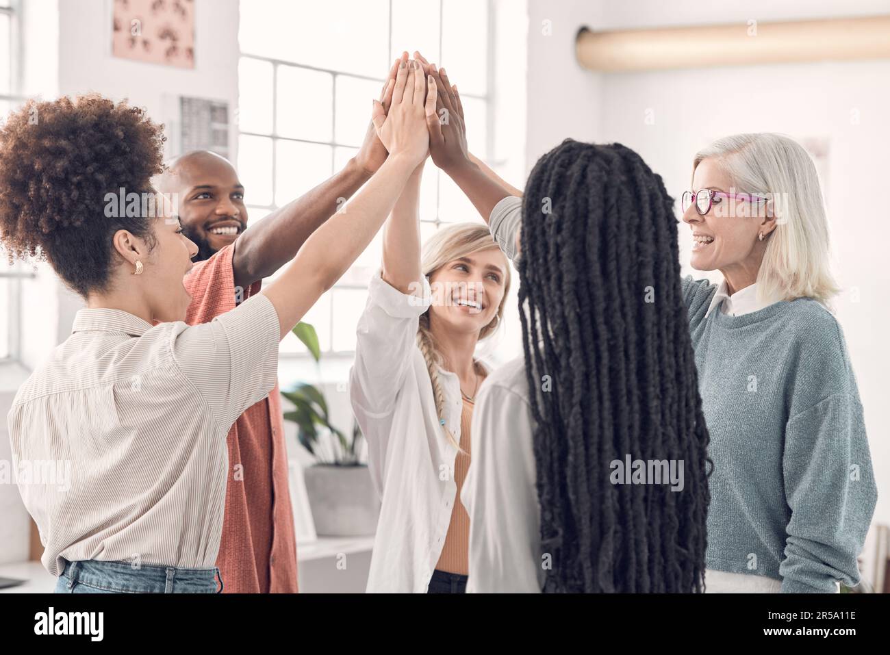 Team work, high five and group of business people with support, goals ...