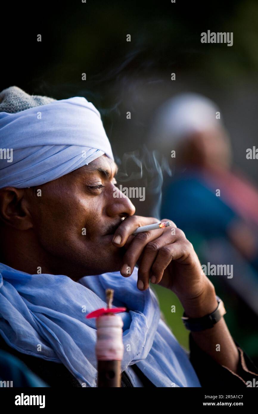 Portrait of an Egyptian man smoking a cigarette on the banks of the ...