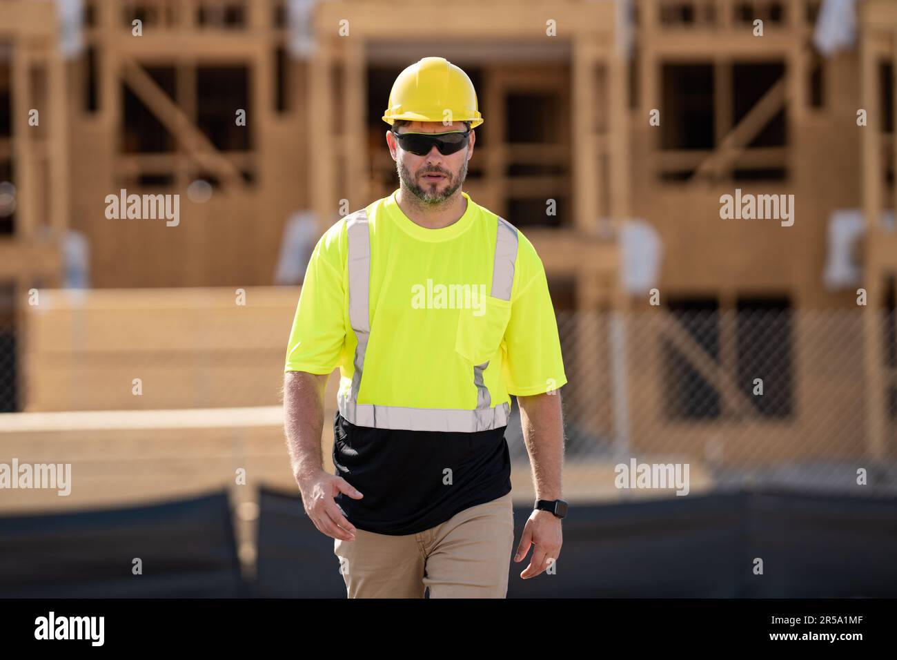 Construction site worker in helmet working outdoor. A builder in a ...