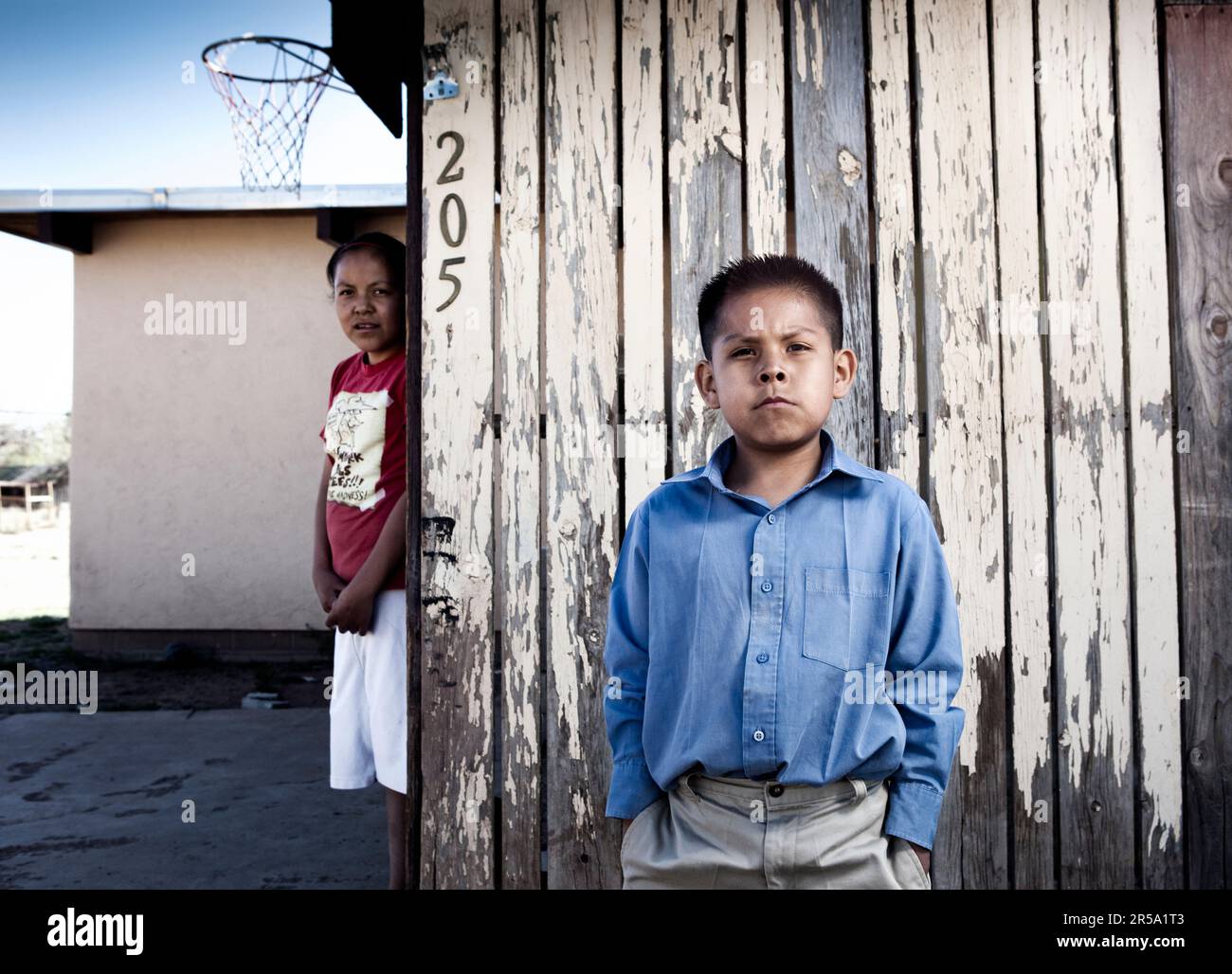A brother and sister wait for their mother to come back from work in ...