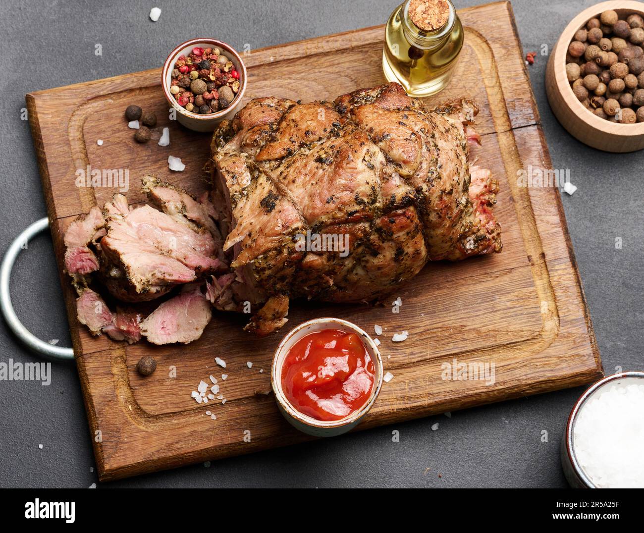 Baked pork collar with spices on a wooden board, delicious and juicy ...