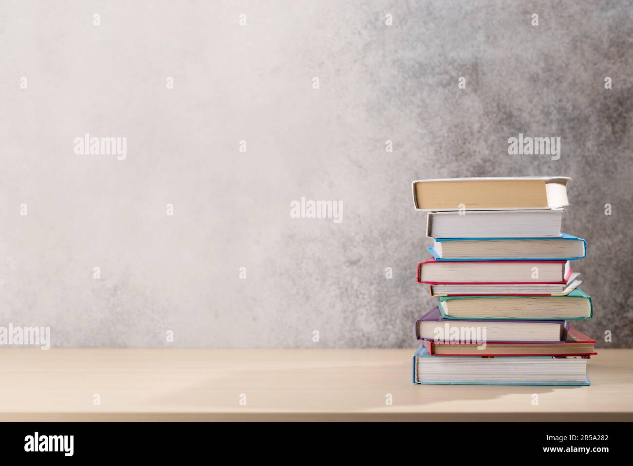 Stack of books on desk and space for creativity Stock Photo - Alamy