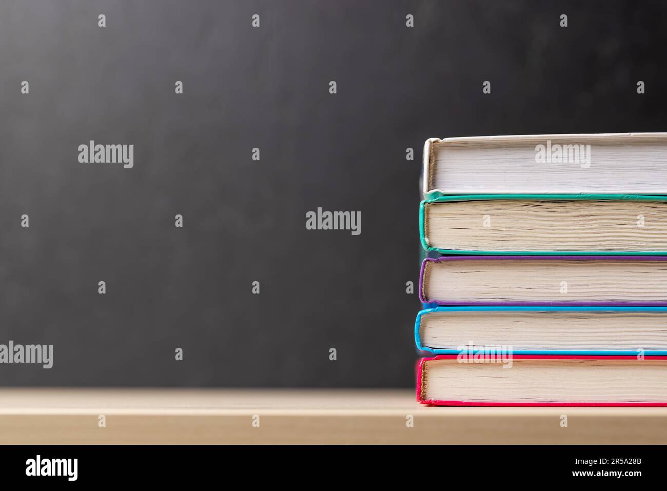 Stack of books on desk with chalkboard and space for creativity Stock ...