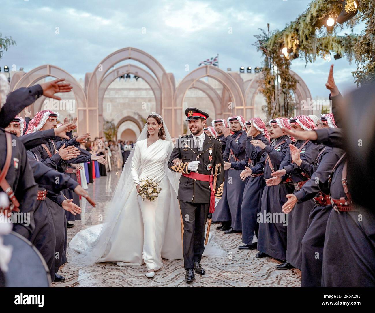 Jordan's Crown Prince Hussein and Saudi Rajwa Alseif walk during their ...