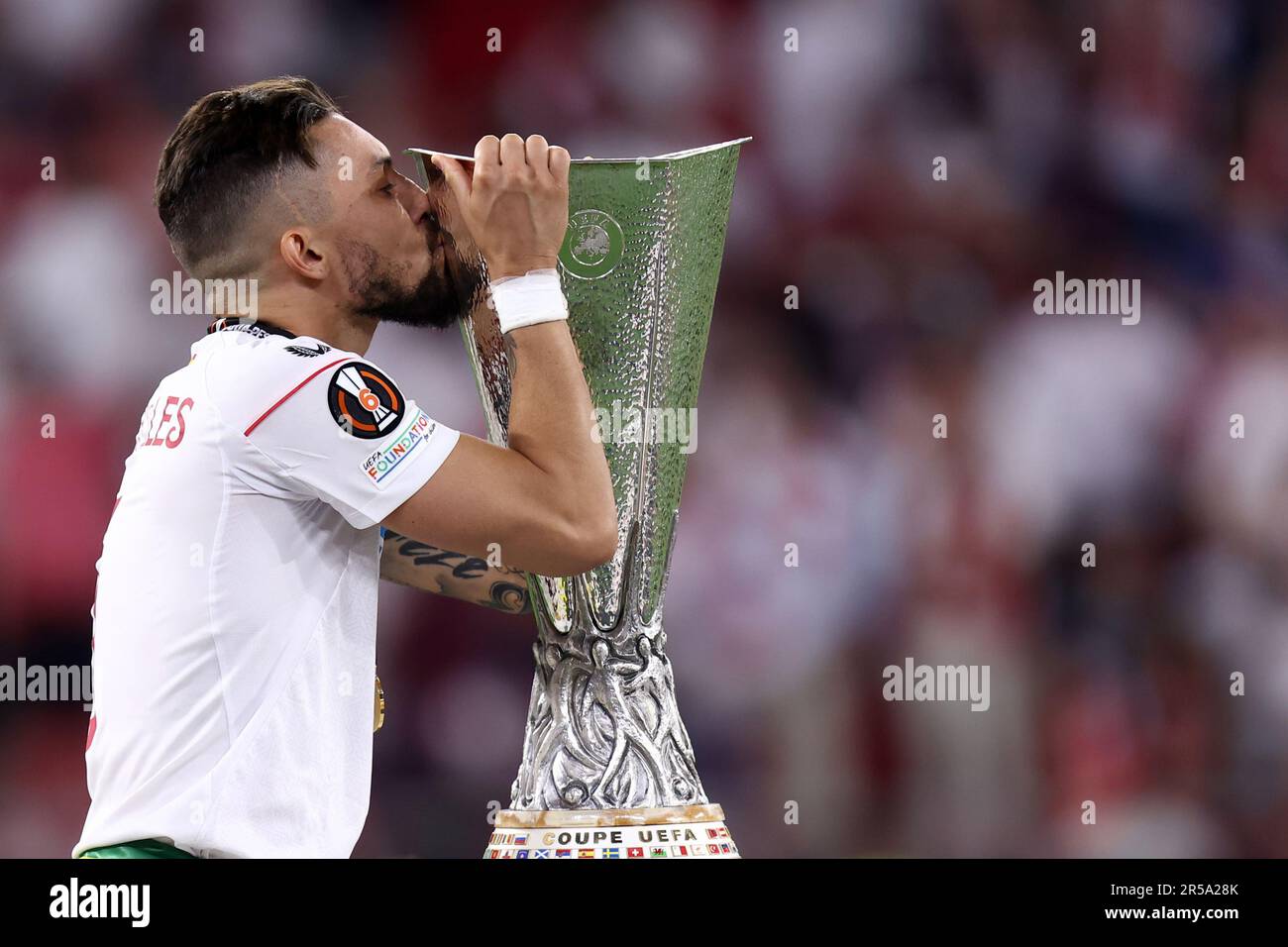 Alex Telles of Sevilla FC kisses the trophy at the end of the UEFA ...