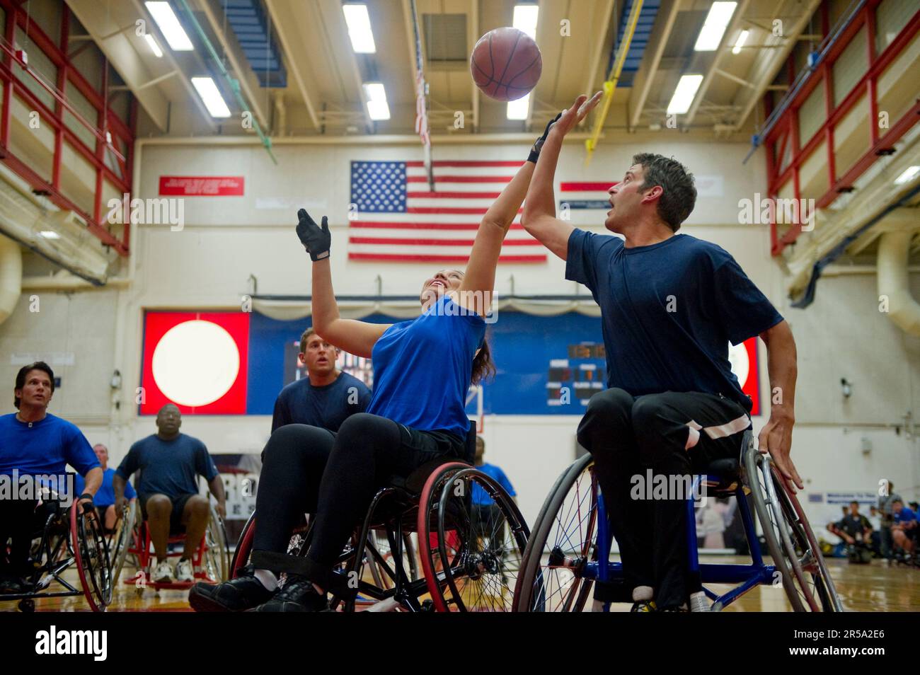 Wheelchair basketball players battle over the ball during a game Stock ...
