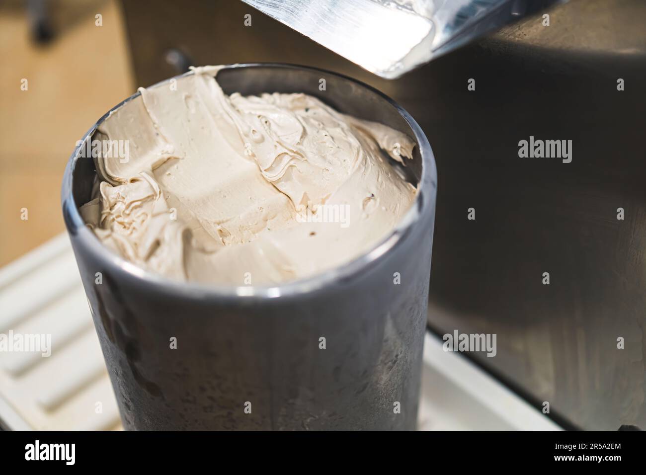 Freshly prepared vanilla ice cream in steel container right from ...