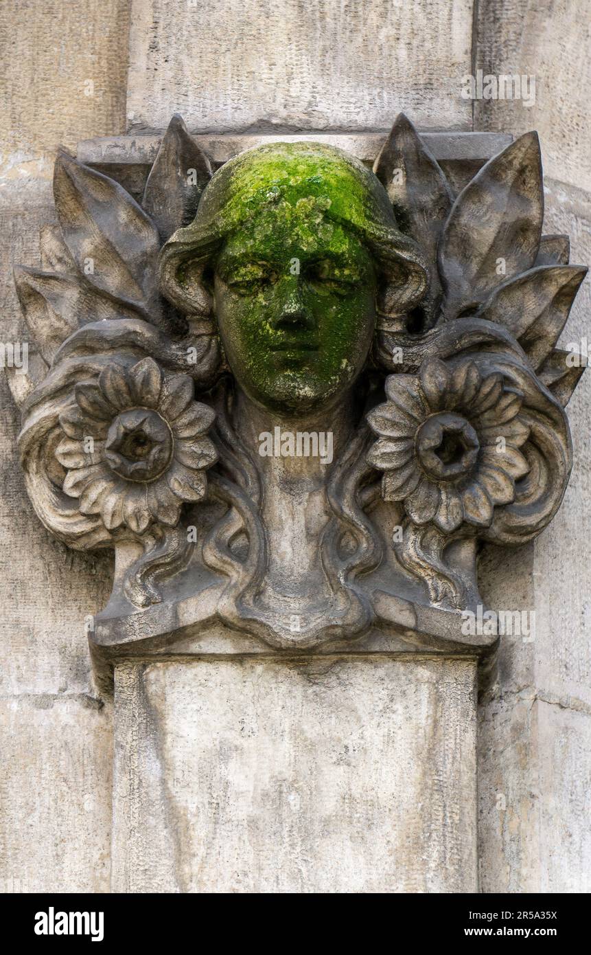 Bas-relief - mascaron girl's face surrounded by flowers and leaves ...