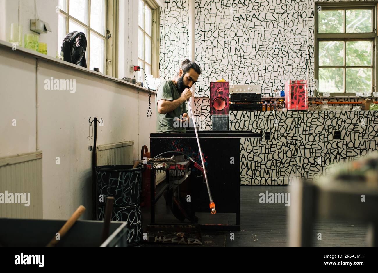 Artisan creative glass blower working in a studio Stock Photo - Alamy