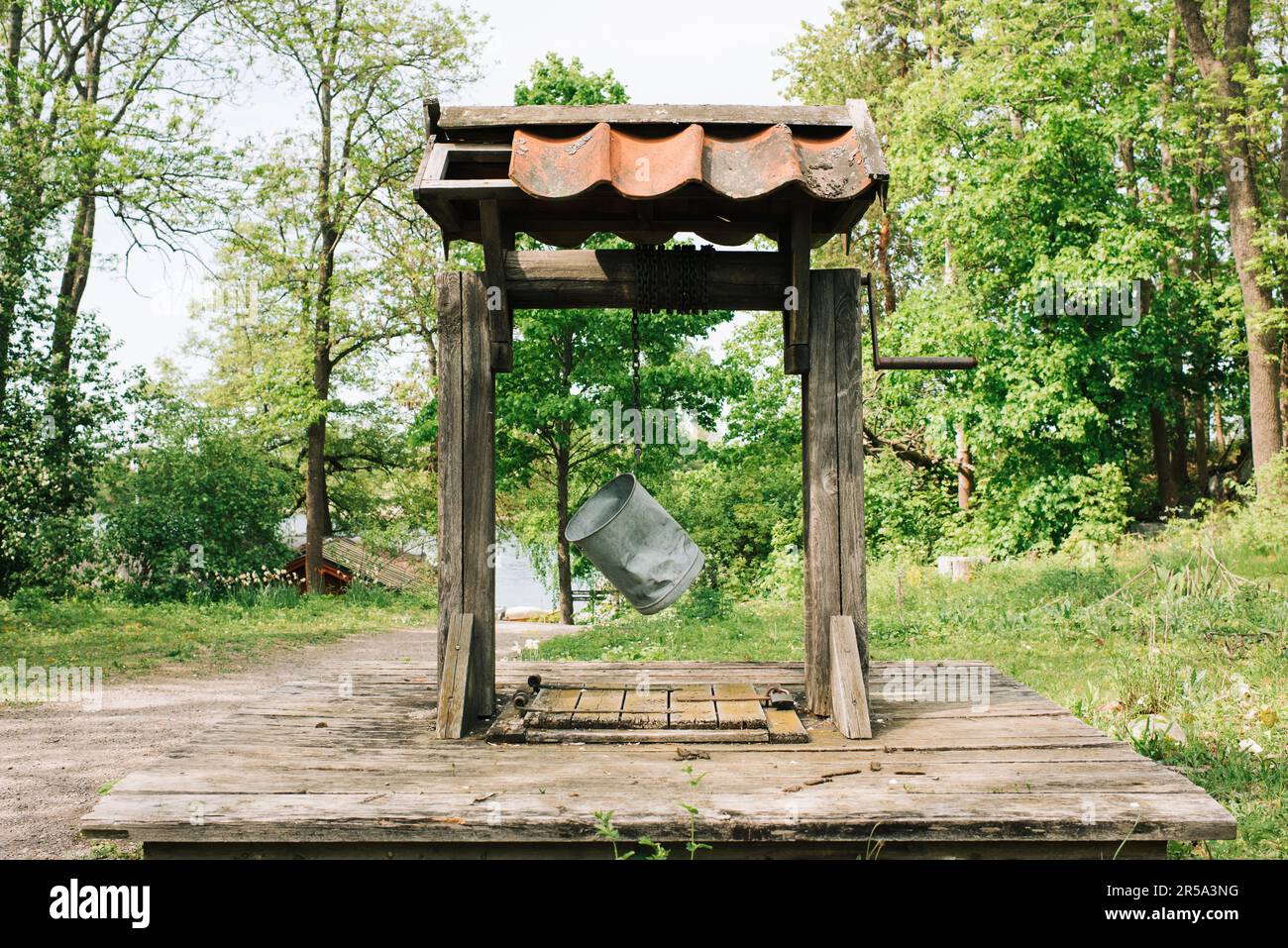old well with a bucket by the water in Sweden Stock Photo - Alamy