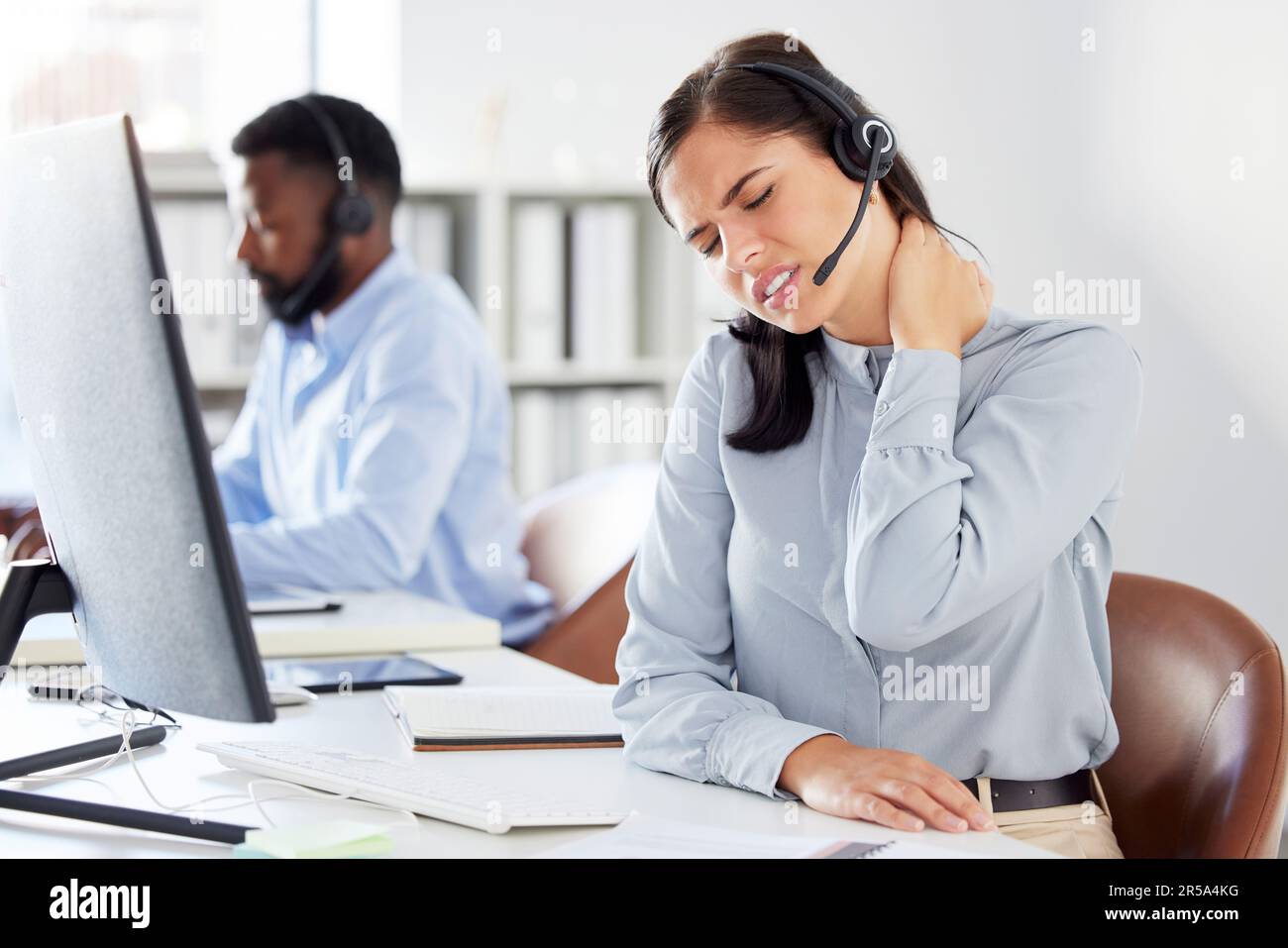 Call center, neck pain and woman with injury in office, arthritis or ...