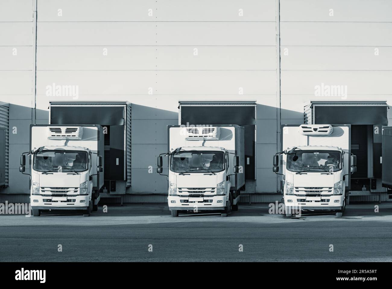 Freight trucks stand by the door of the storage Stock Photo - Alamy