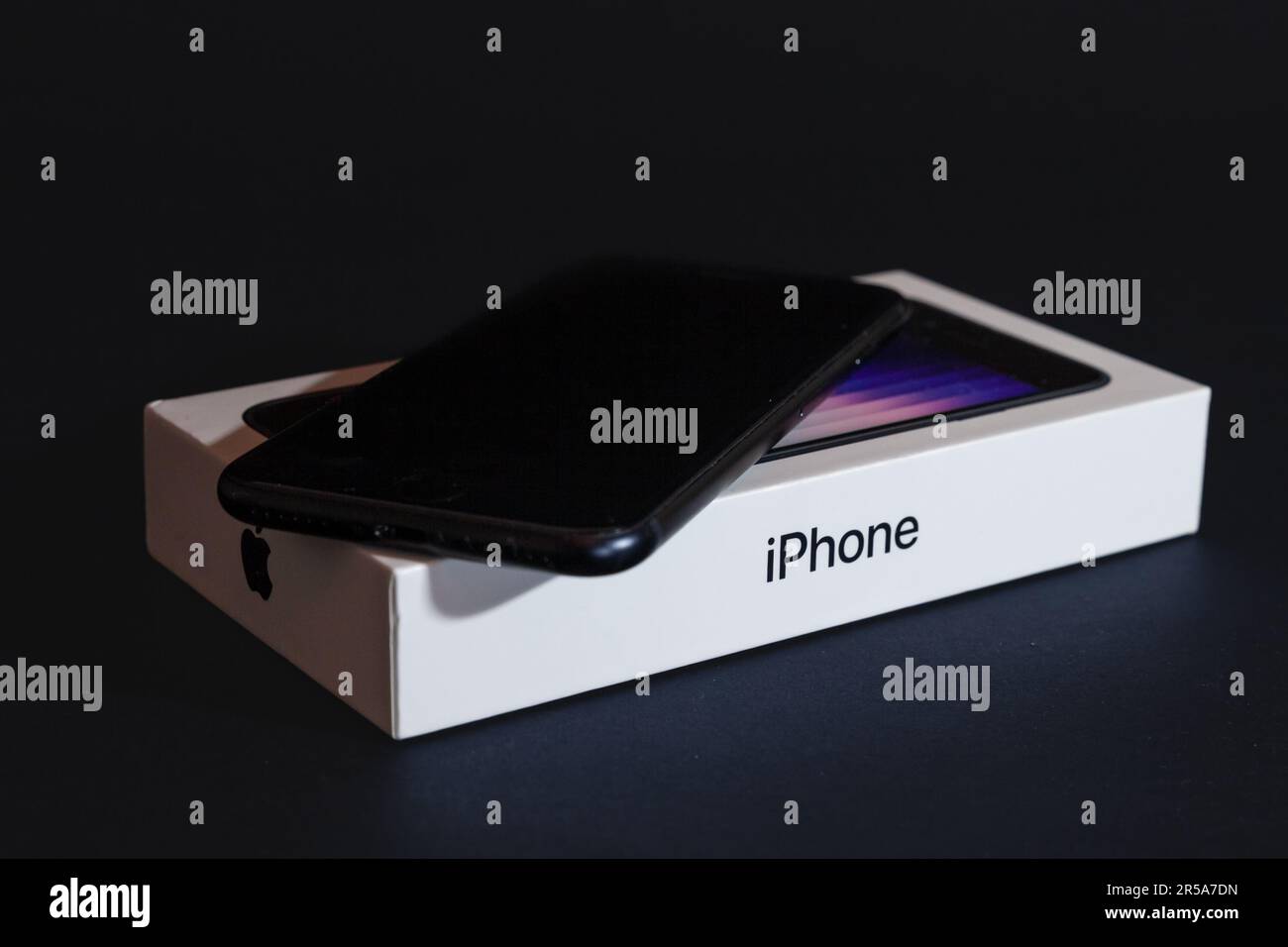 Picture of an Apple Iphone SE3 on a black background. The third ...