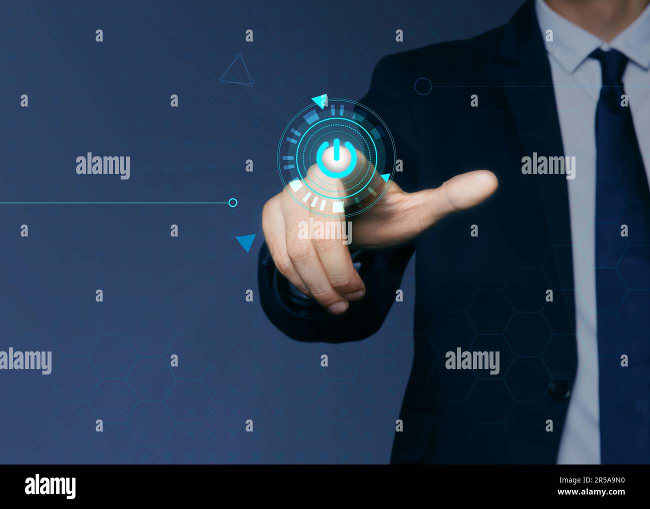 Man pressing start button on virtual screen against dark blue ...