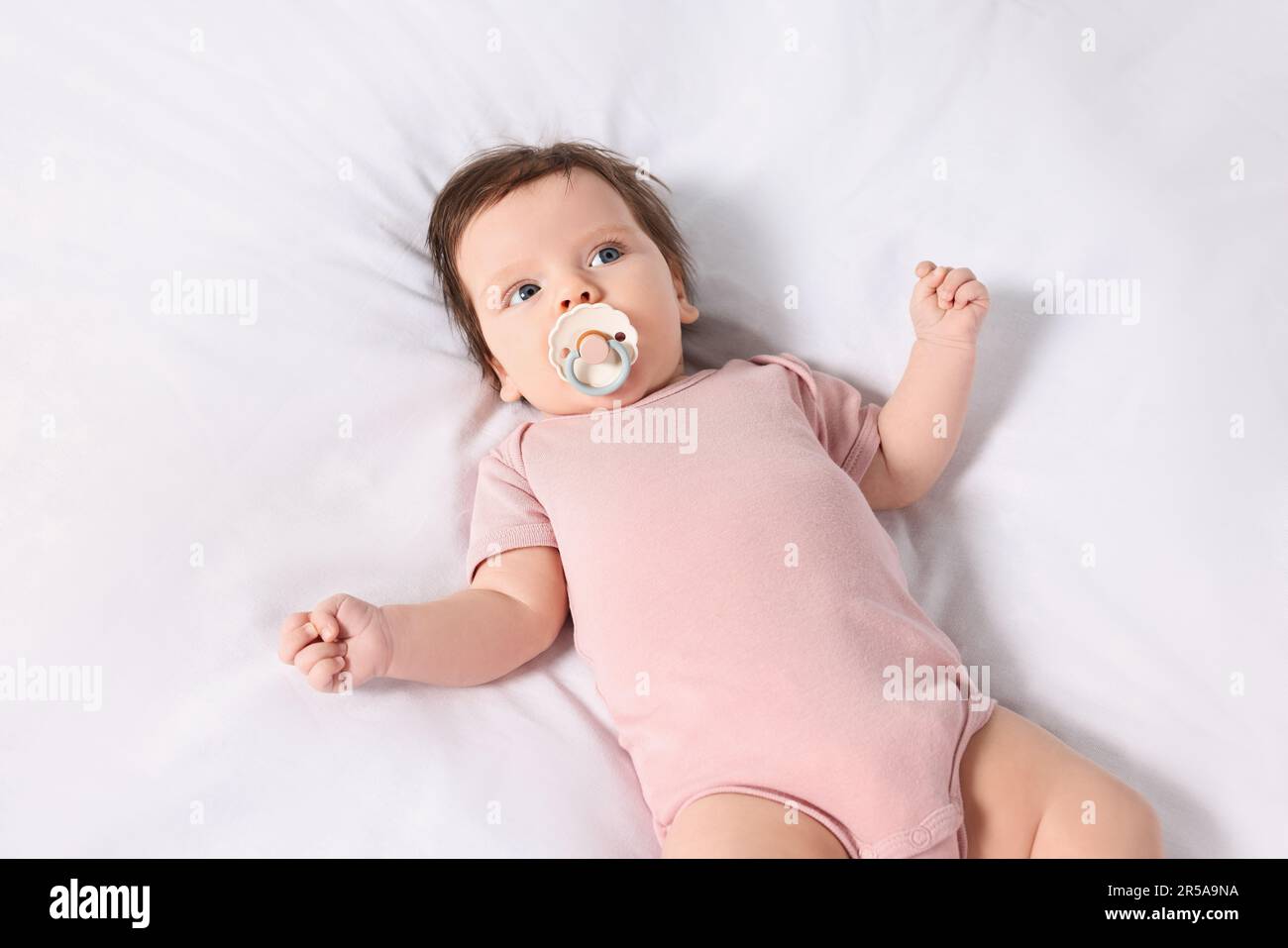 Cute little baby on cosy bed, top view Stock Photo - Alamy
