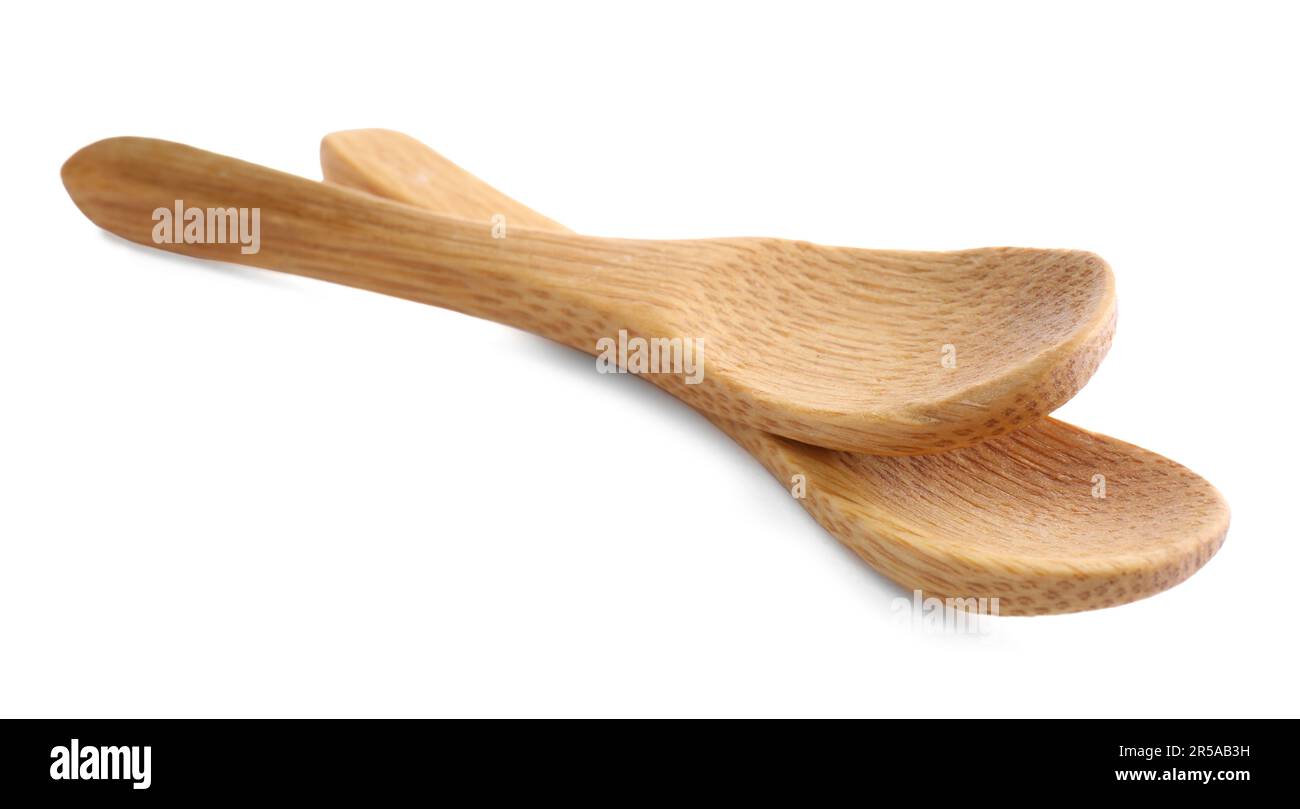 Two new wooden spoons on white background Stock Photo - Alamy