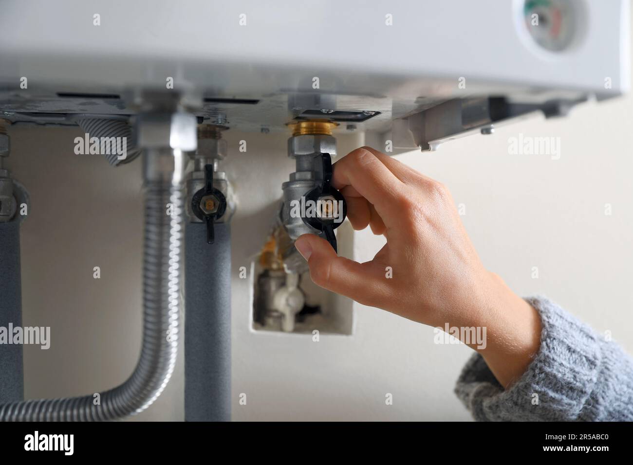 Woman turning on gas hi-res stock photography and images - Alamy