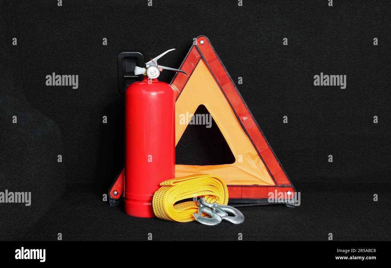 Red fire extinguisher, towing strap and foldable emergency warning ...