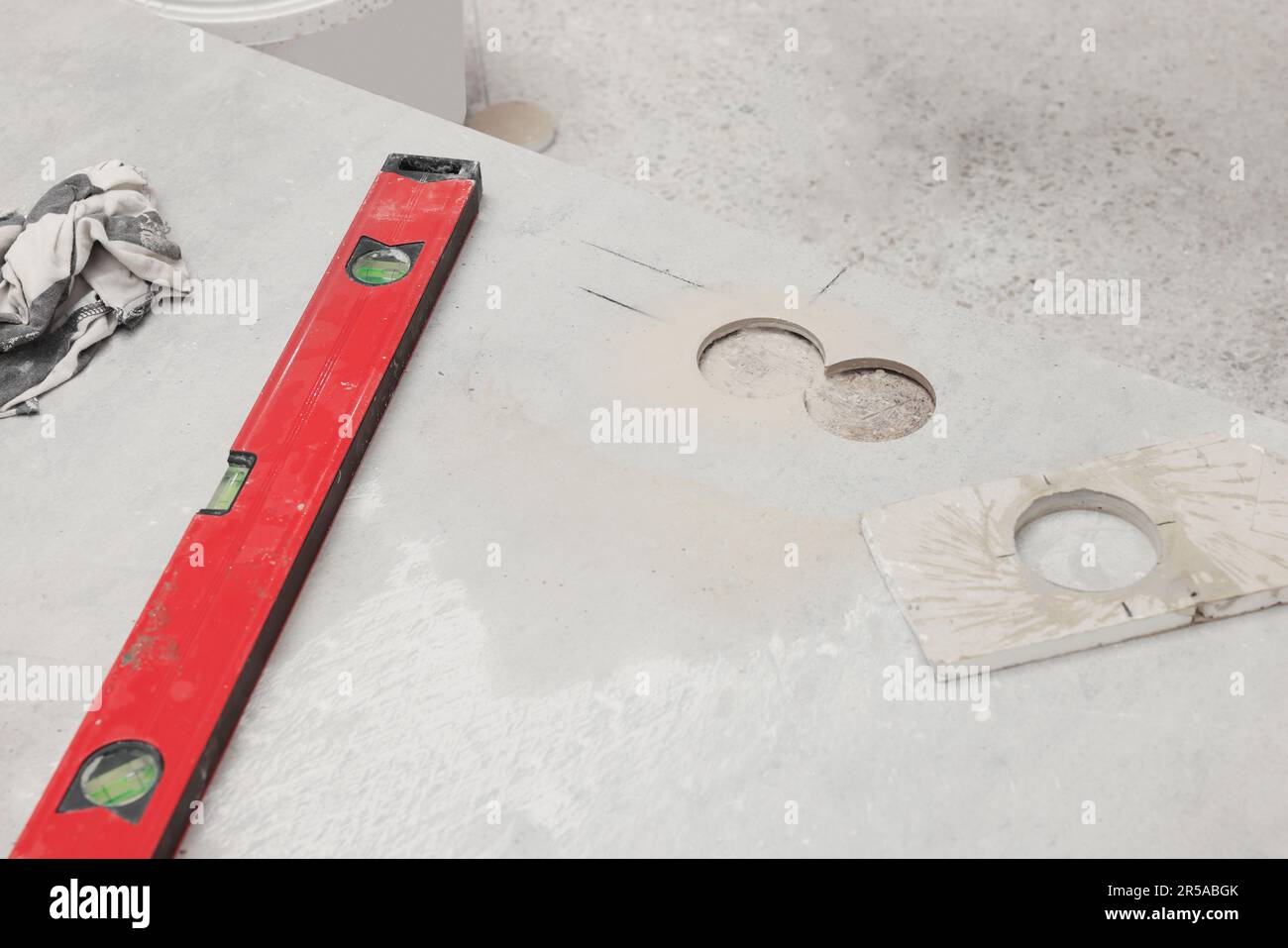 Socket holes and building level on tile indoors Stock Photo - Alamy