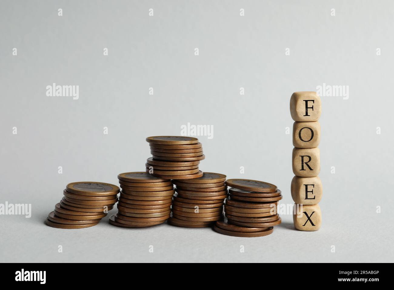 Word Forex made of wooden cubes with letters and stacked coins on light ...