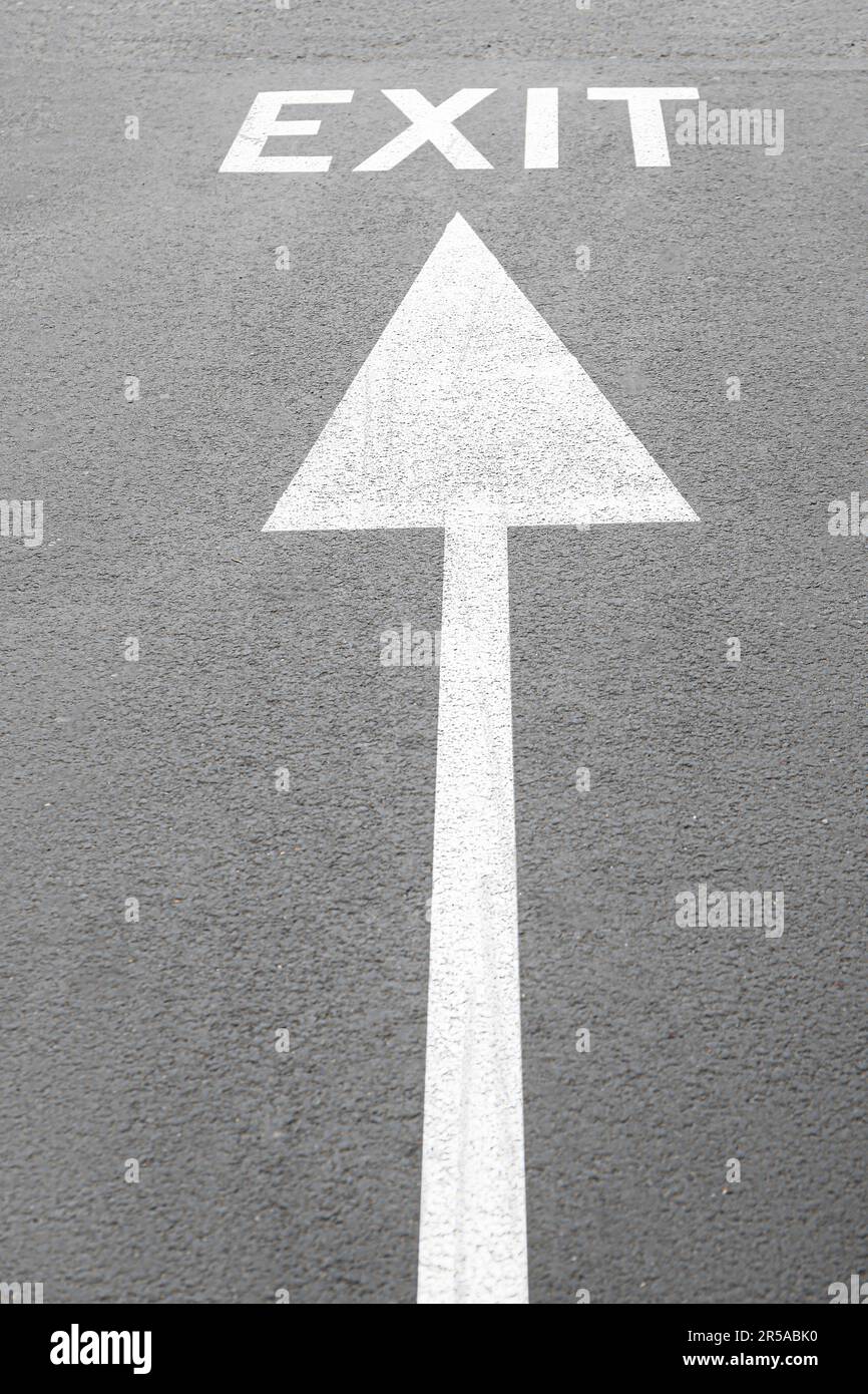 White painted arrow and exit marking on road outdoors Stock Photo - Alamy