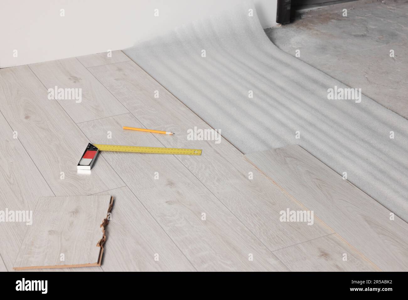 Ruler, pencil and parquet plank on laminated flooring indoors Stock ...