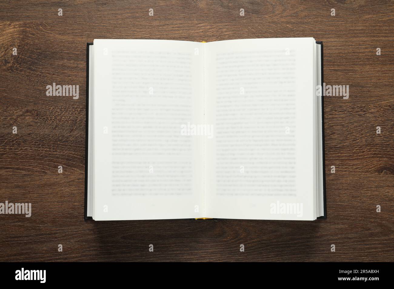 Open book on wooden table, top view Stock Photo - Alamy