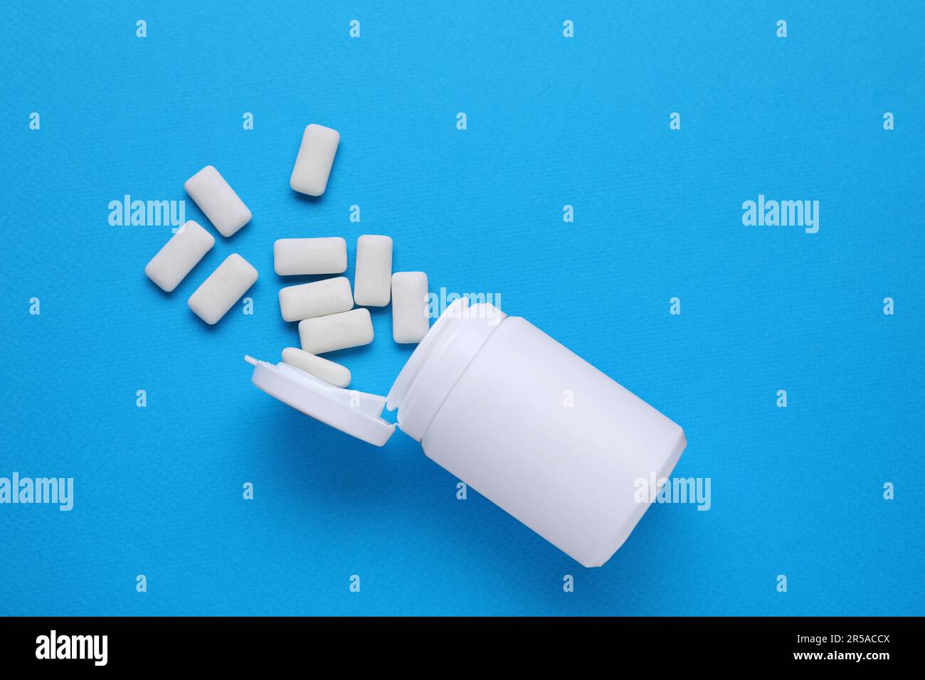 Jar with chewing gums on light blue background, flat lay Stock Photo ...