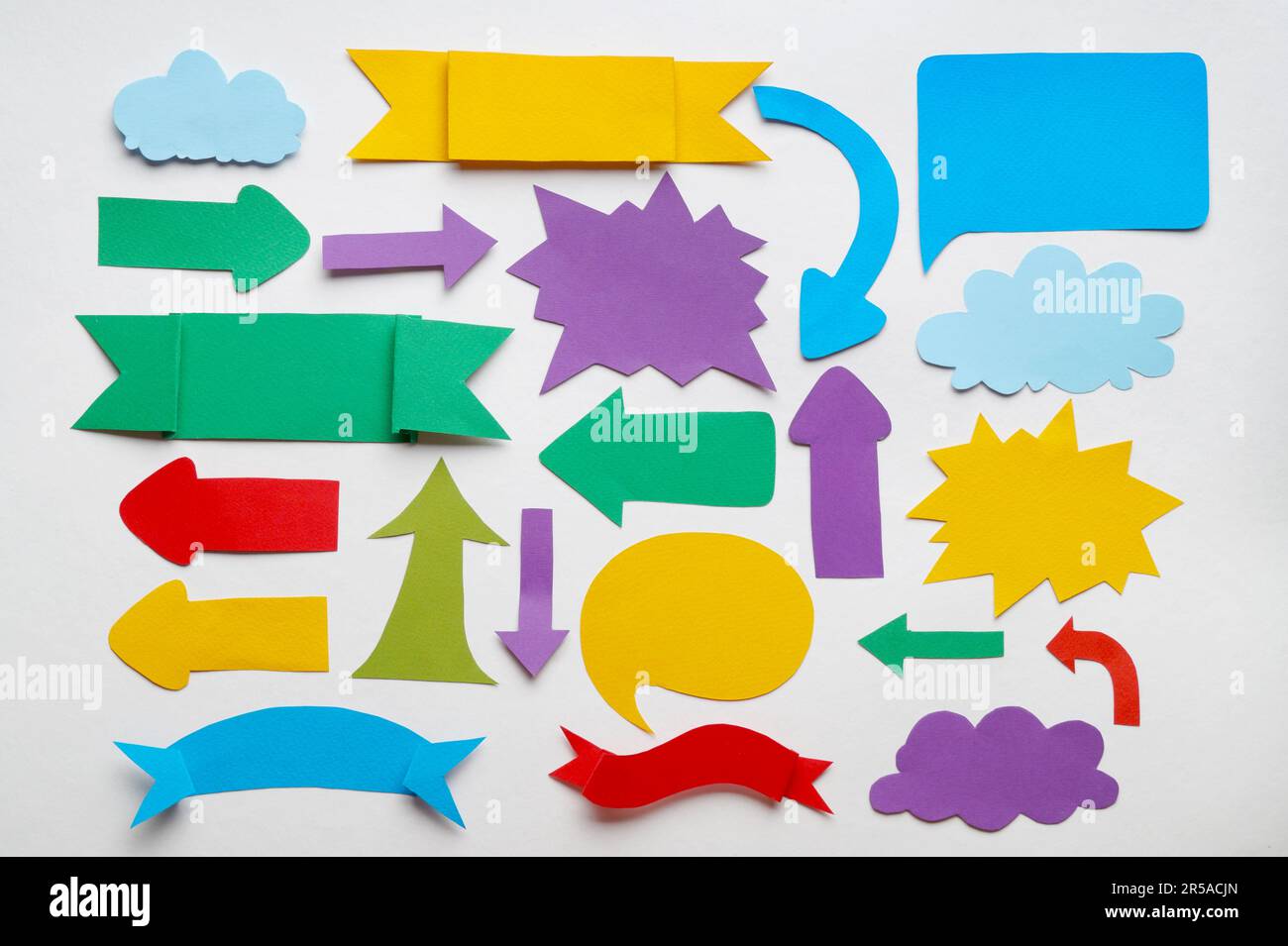 Different speech bubbles and arrows on white background, flat lay ...