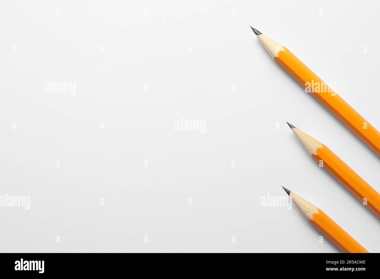 Sharp graphite pencils on white background, flat lay. Space for text ...