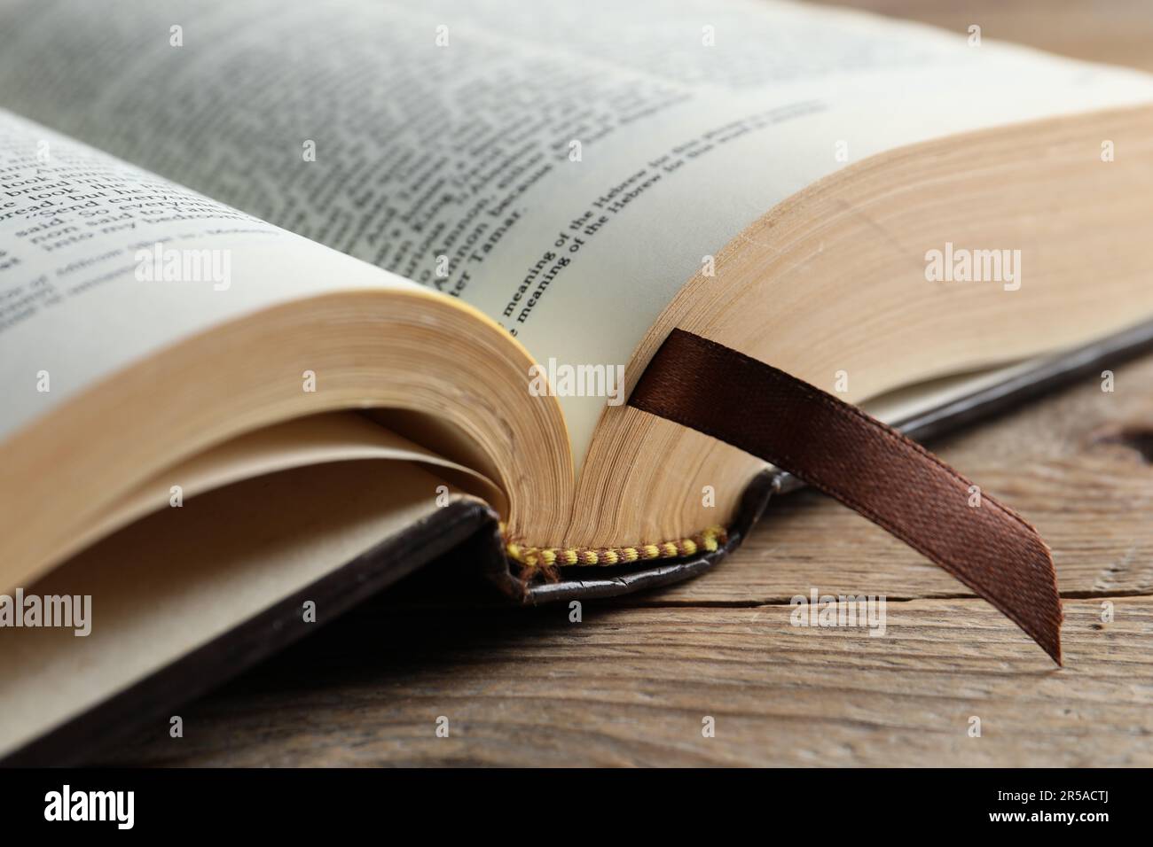 Open Bible on wooden table, closeup. Christian religious book Stock ...