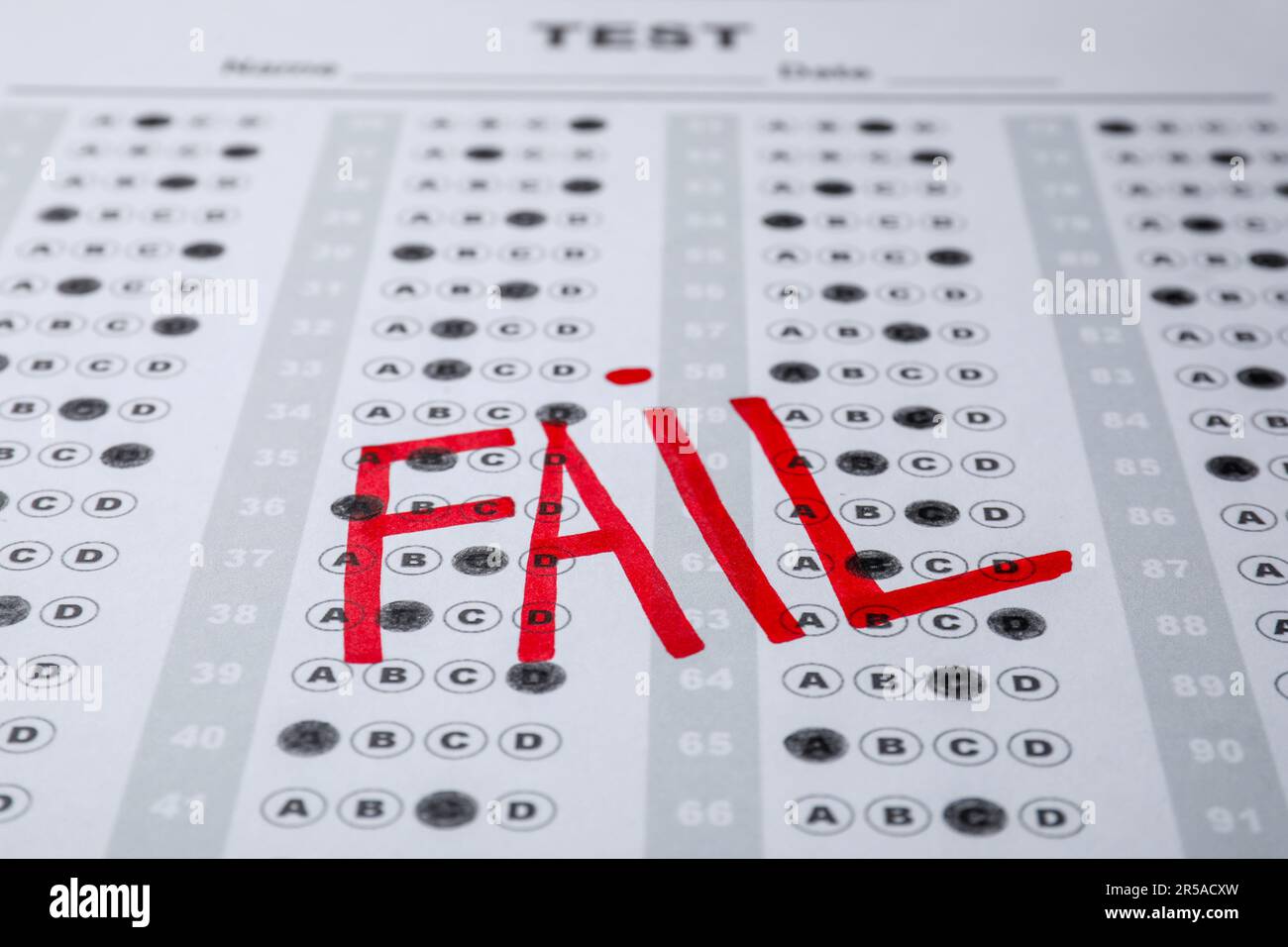Word Fail written with red marker on answer sheet, closeup. Student ...