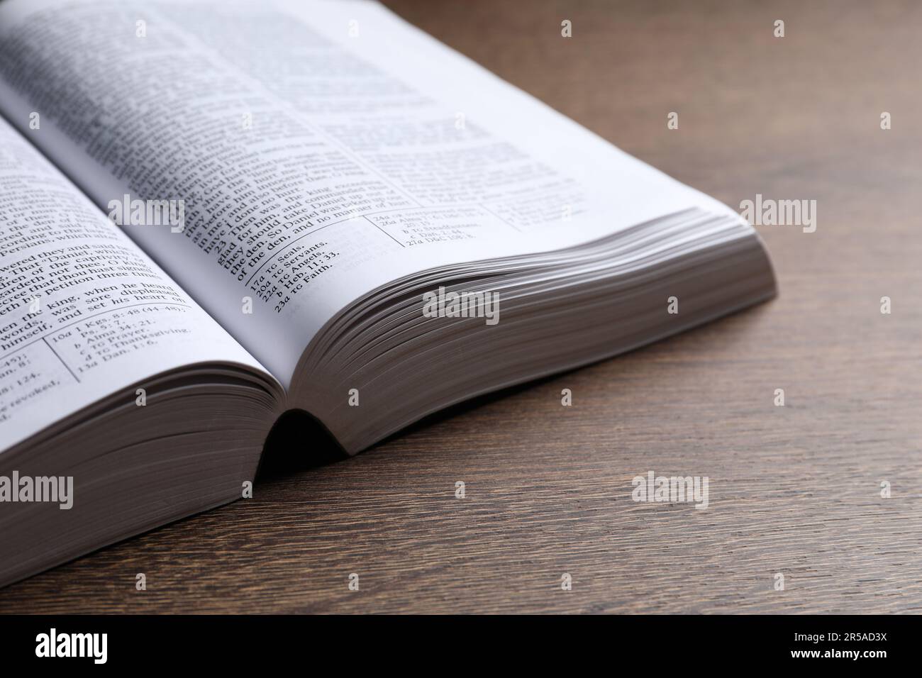 Open Bible on wooden table, closeup. Religious book Stock Photo - Alamy